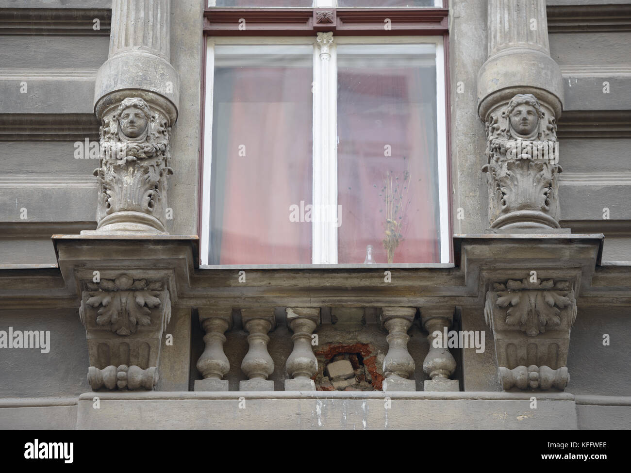 Close-up ornate window frame with sculptured column pedestals and ...