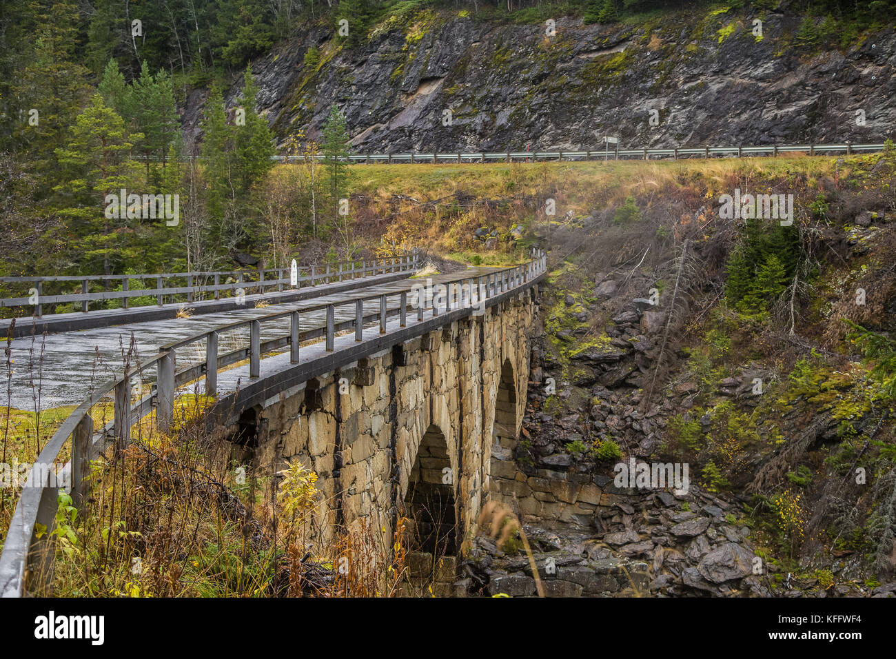 A beautiful historic stone bridge crossing the river in central Norway ...