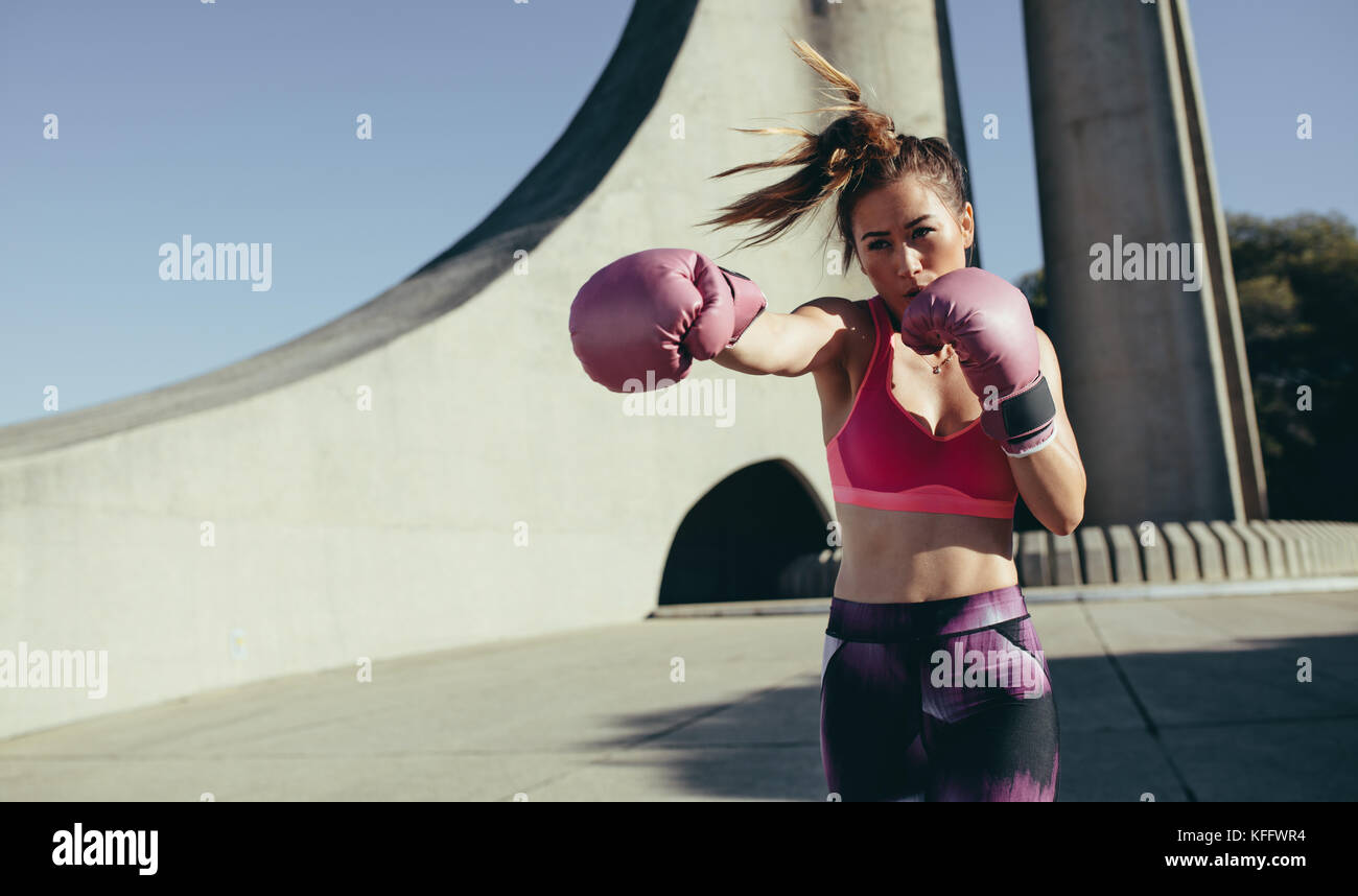 sportswoman doing boxing working outdoors. Female practicing boxing ...