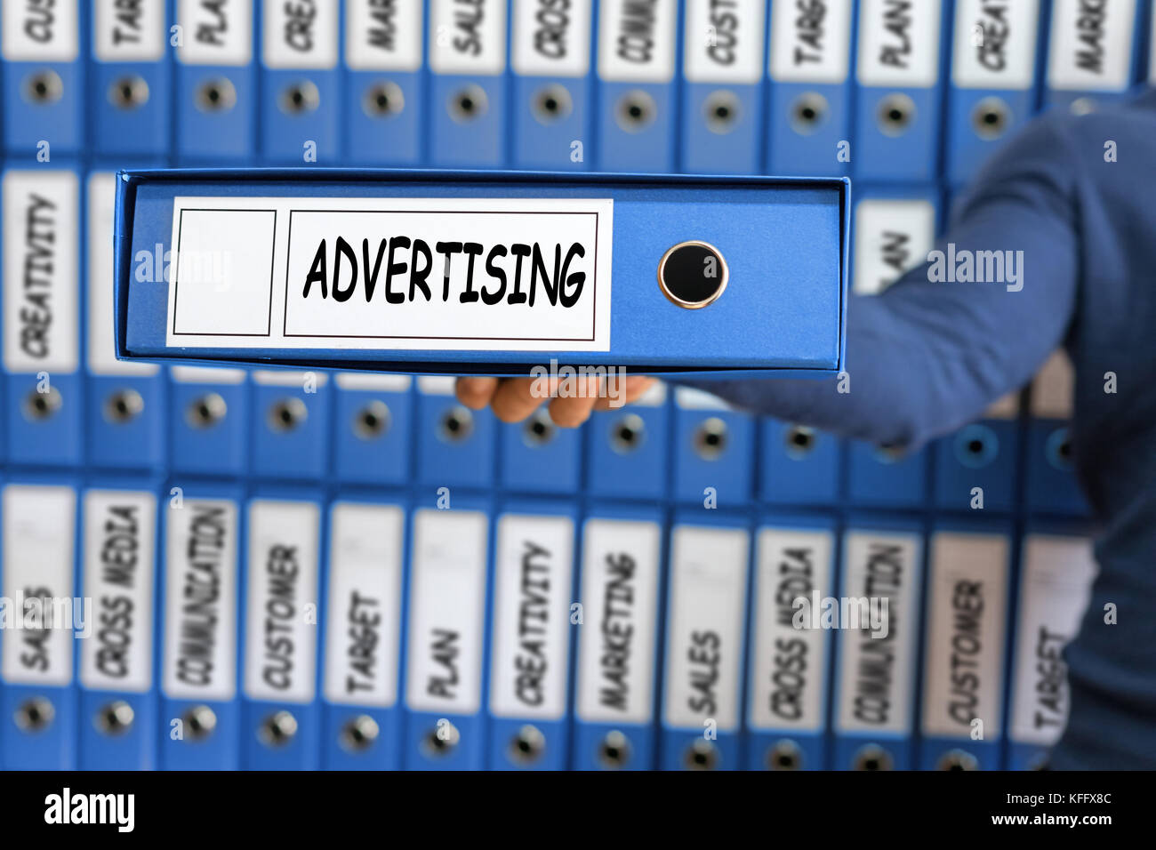 Advertising concept, young man holding ring binder Stock Photo - Alamy