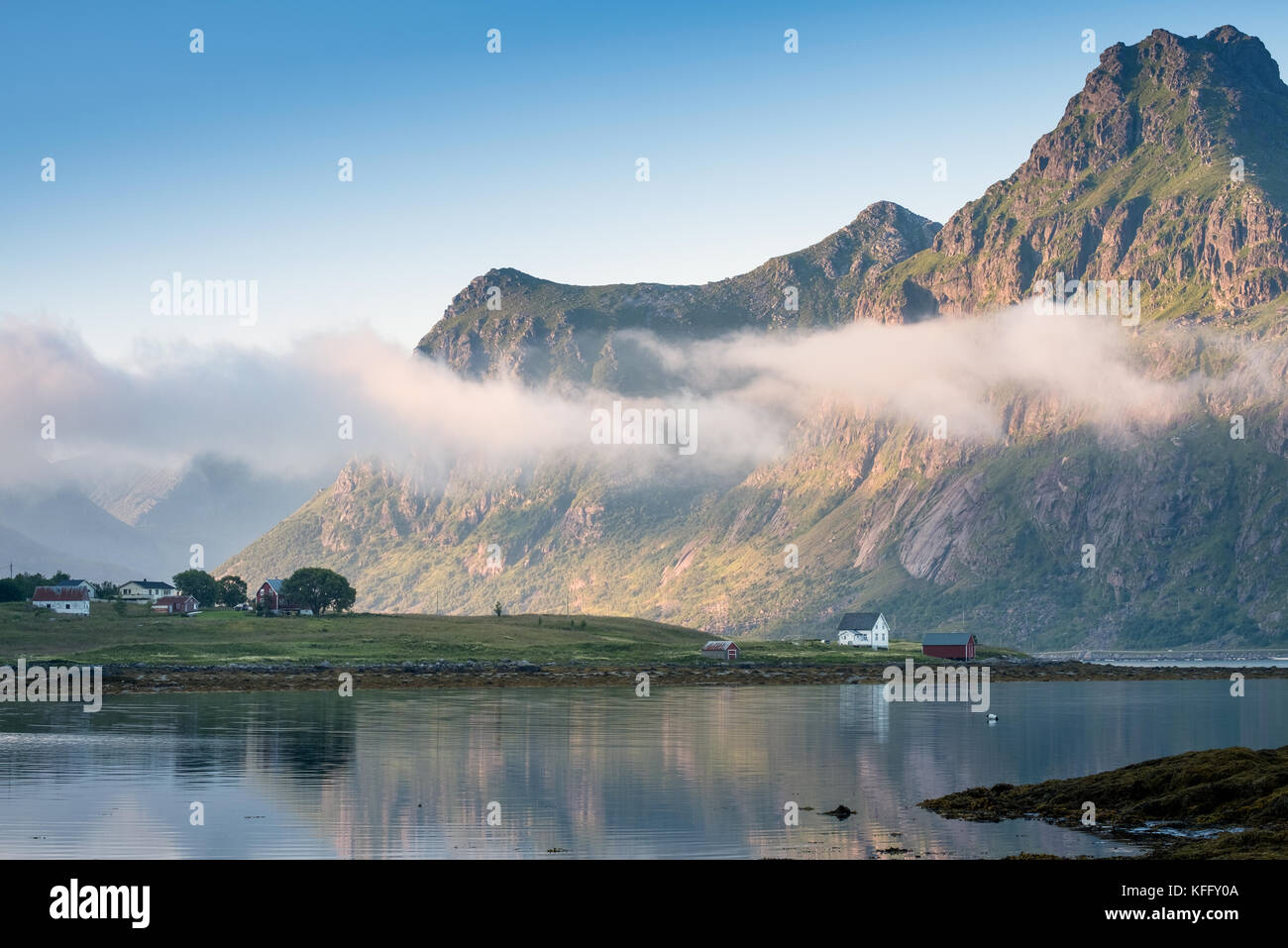 Scenic view with idyllic house and mountains at summer evening in ...
