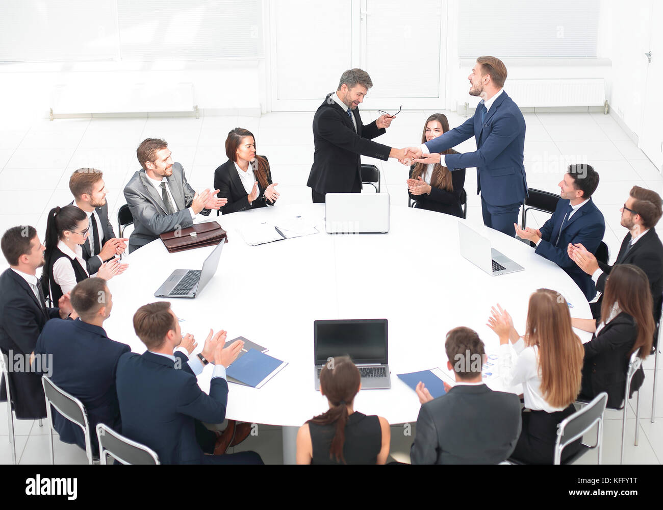 business partners shake hands at the talks near the round table .the ...