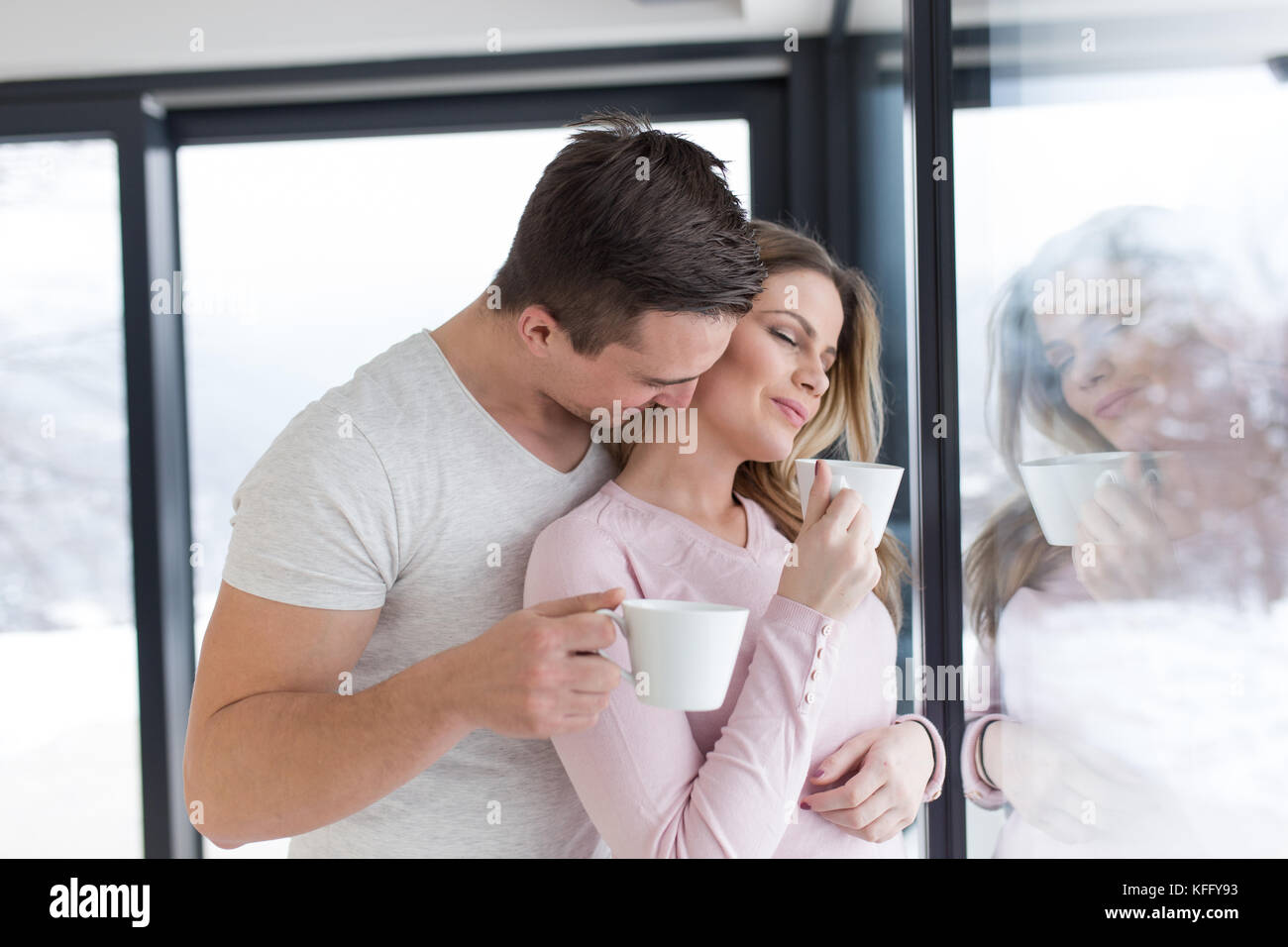 romantic happy young couple enjoying morning coffee by the window on ...