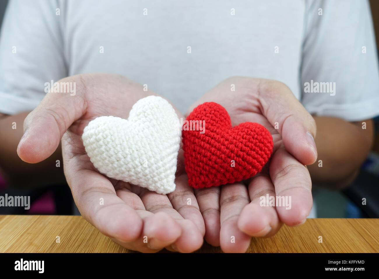 Red and white heart in man hands - giving red and white heart Stock ...