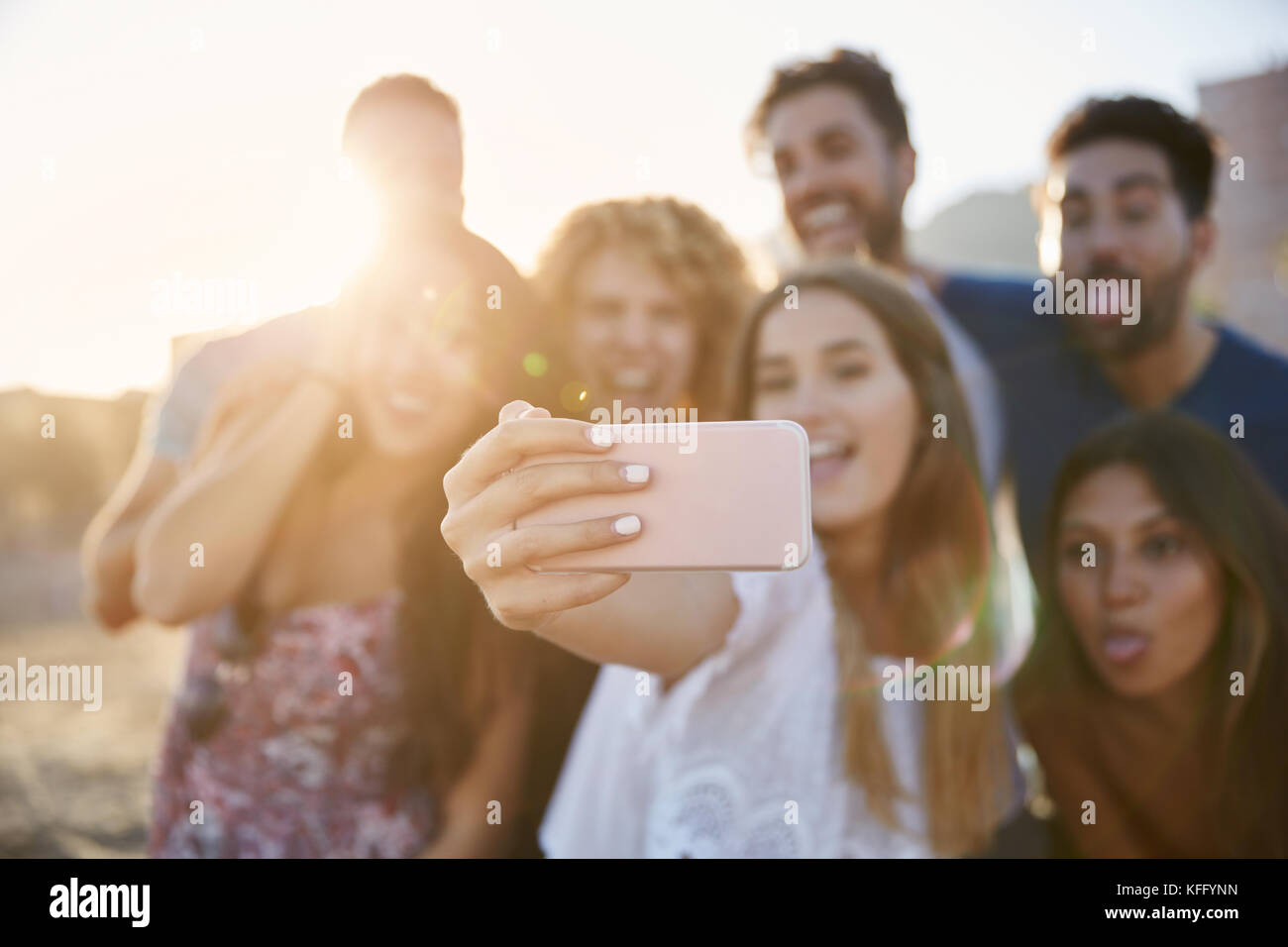Blurred portrait of group of friends making faces to selfie Stock Photo ...