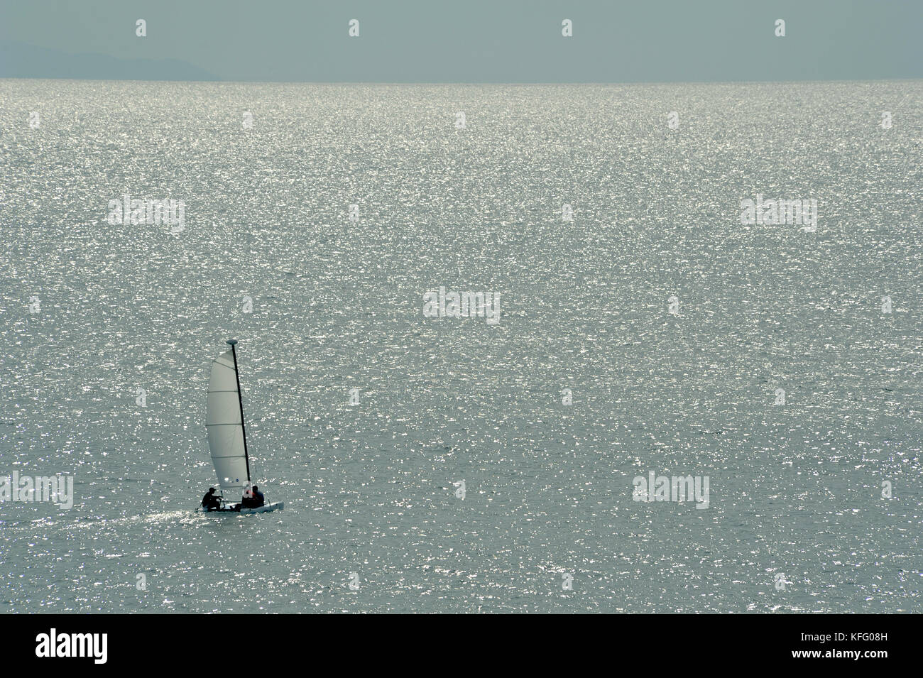 Small sail boat heading to the sea away from the shore Stock Photo - Alamy