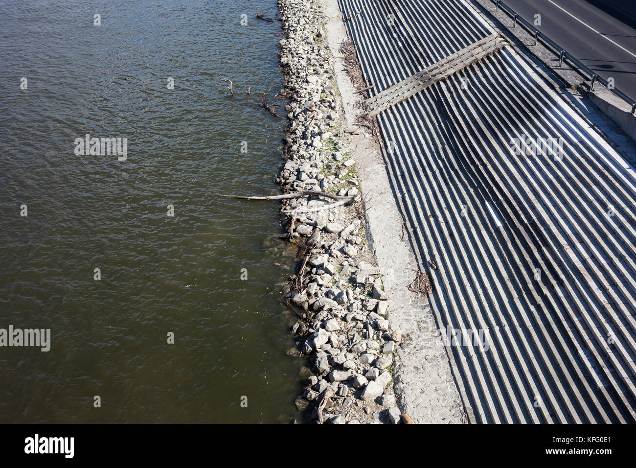 Long Danube river embankment with steps to the water and rocky ...