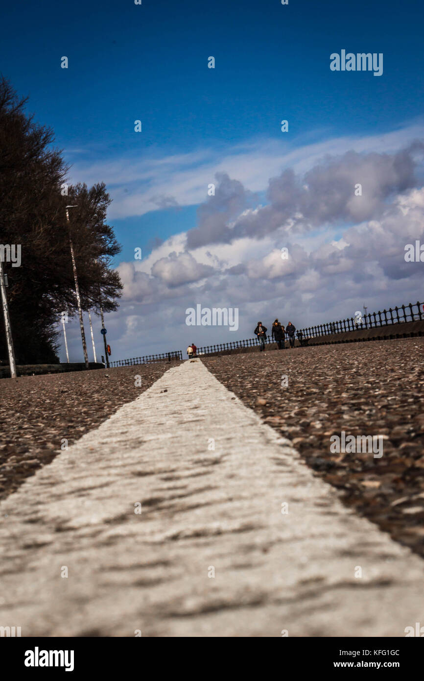 looking down the white line in the centre of a road or walkway with ...