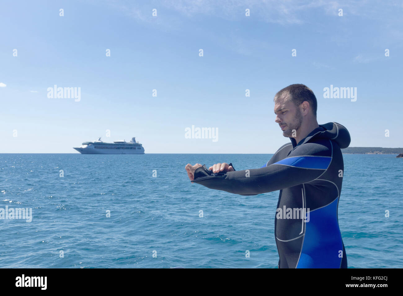 Scuba diver on boat, putting on his wetsuit Stock Photo - Alamy