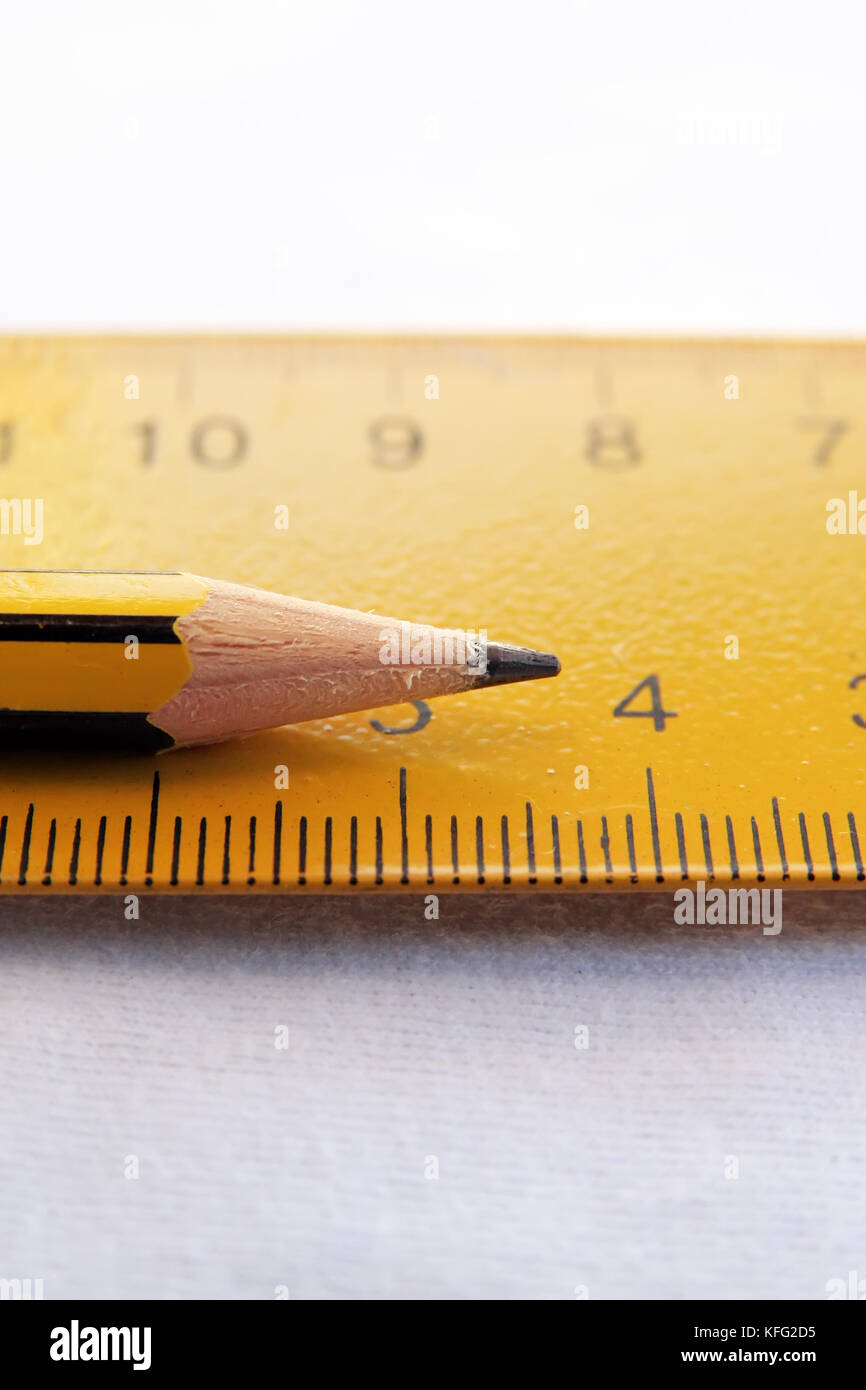 Drawing tools. Yellow pencil and a meter Stock Photo - Alamy
