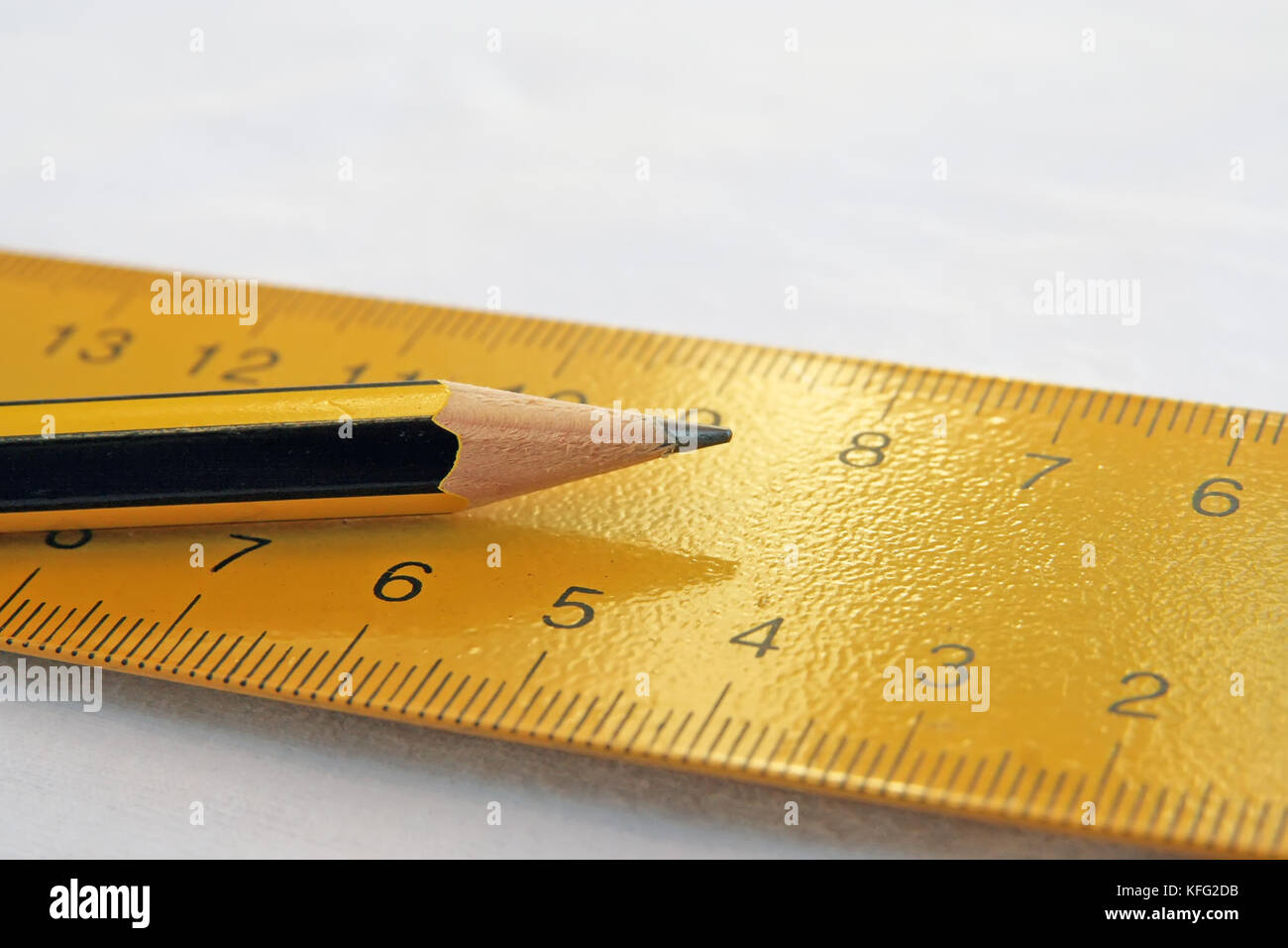 Drawing tools. Yellow pencil and a meter Stock Photo - Alamy