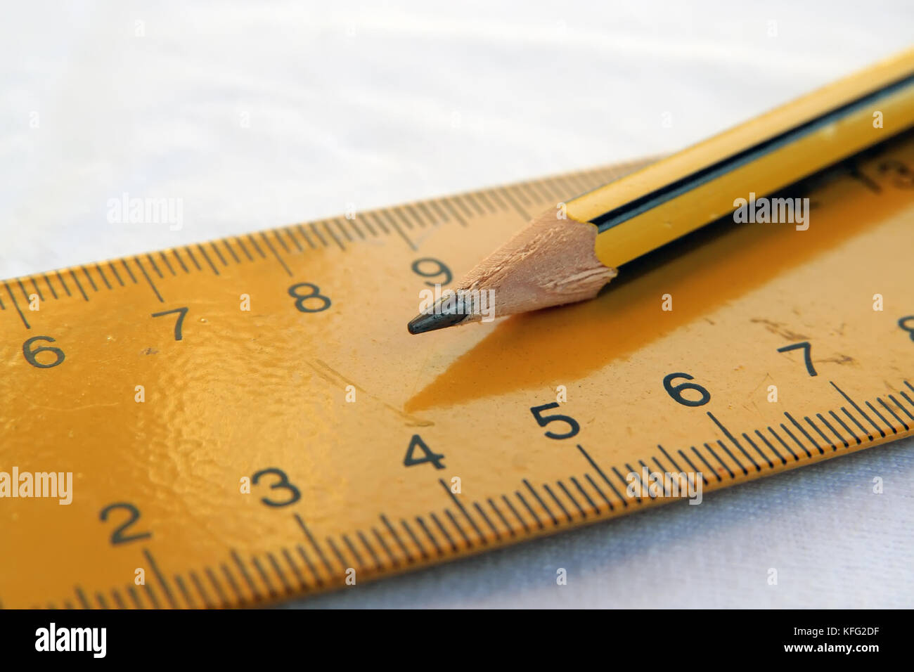 Drawing tools. Yellow pencil and a meter Stock Photo - Alamy