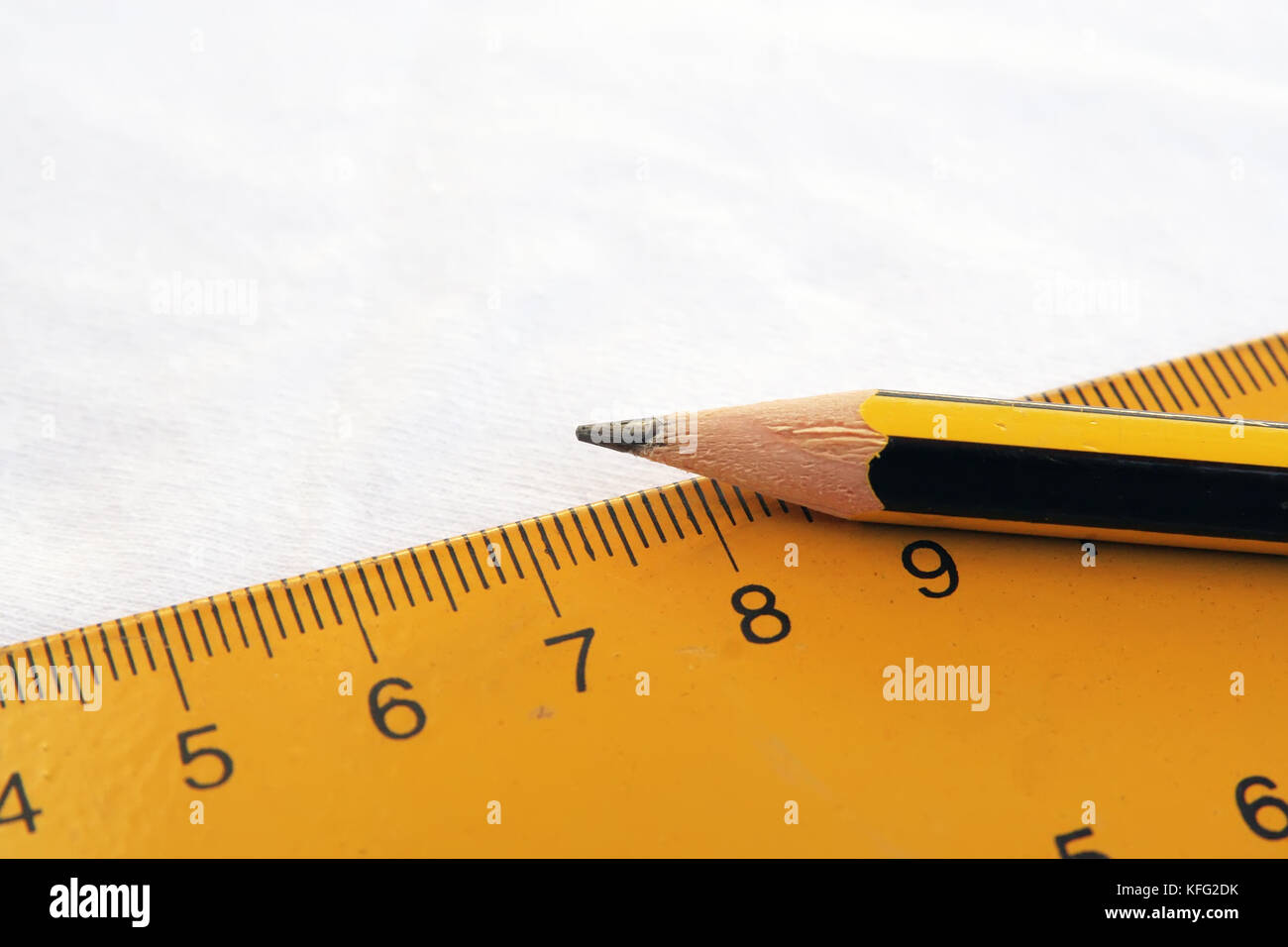 Drawing tools. Yellow pencil and a meter Stock Photo - Alamy