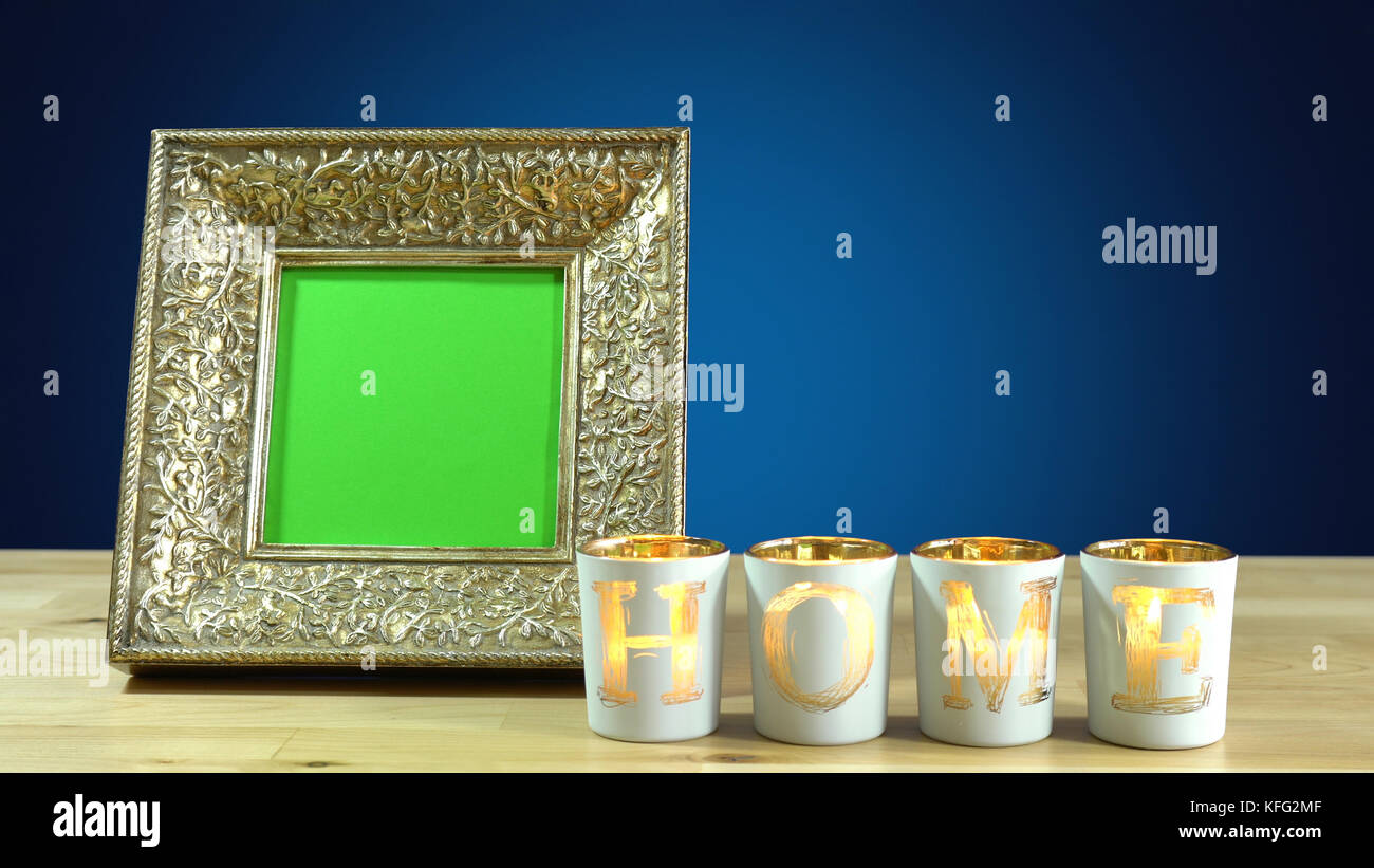 Antique photo frame with green screen and burning home candles in ...