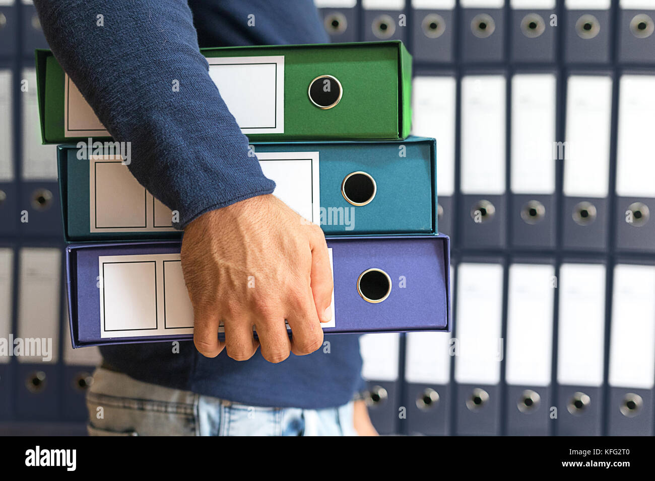 Man holding, corporate files in document binder Stock Photo - Alamy