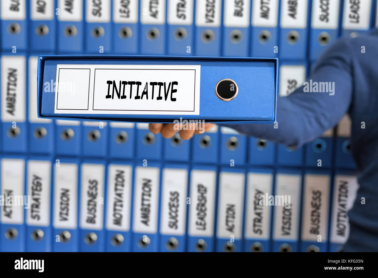 Initiative concept. Young man holding ring binder Stock Photo - Alamy