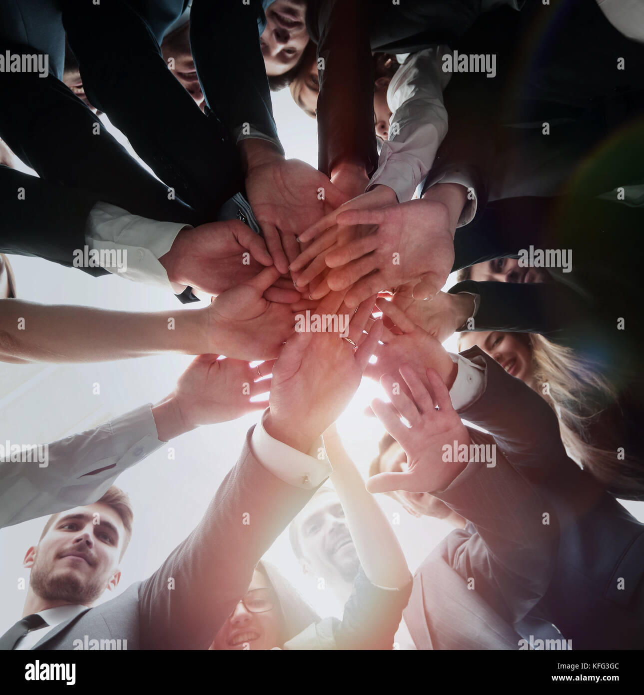 Large business team showing unity with their hands together Stock Photo - Alamy
