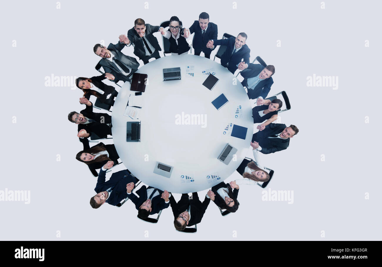 the view from the top. friendly business team sitting at a round table ...
