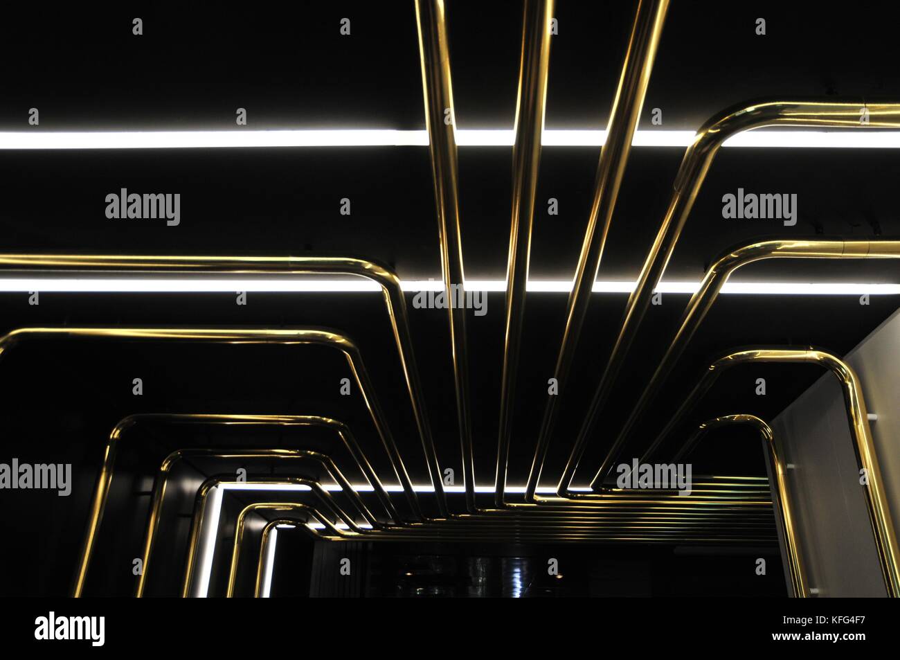 Golden pipes layout in indoor setting Stock Photo - Alamy