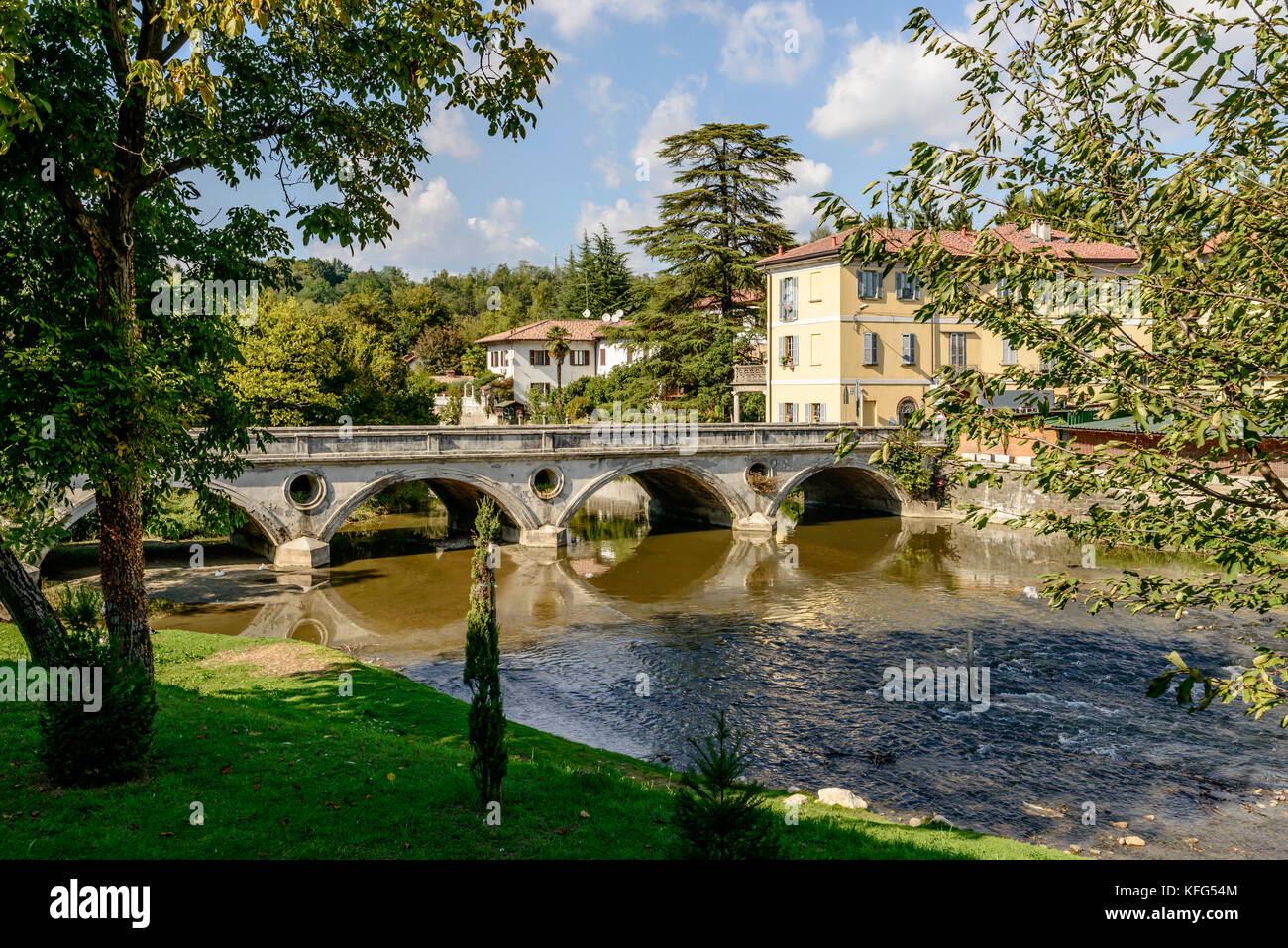 old bridge over Lambro river, shot in bright late summer light at ...