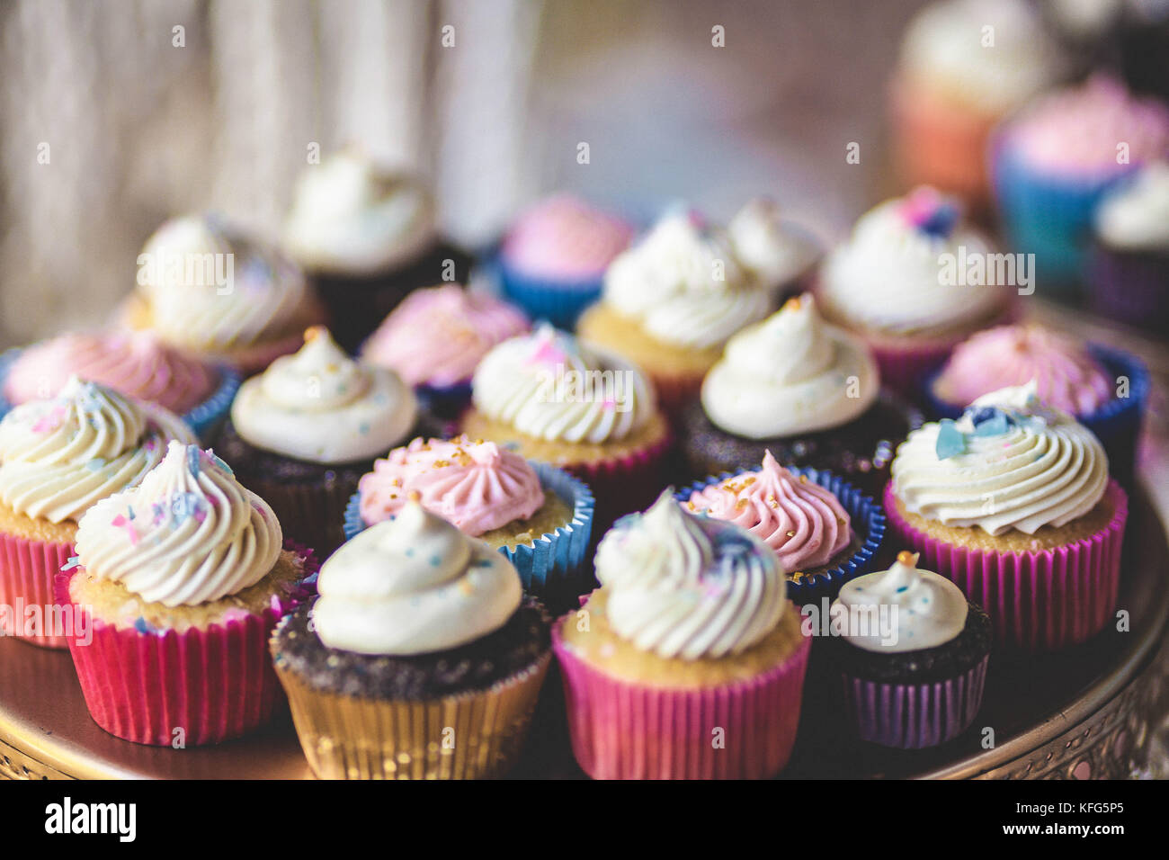 Colorful assorted frosted cupcakes Stock Photo - Alamy
