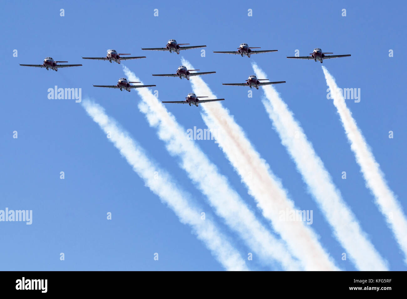 Nine CT-114 Tutor jets of the Canadian Snowbirds pass overhead in a ...