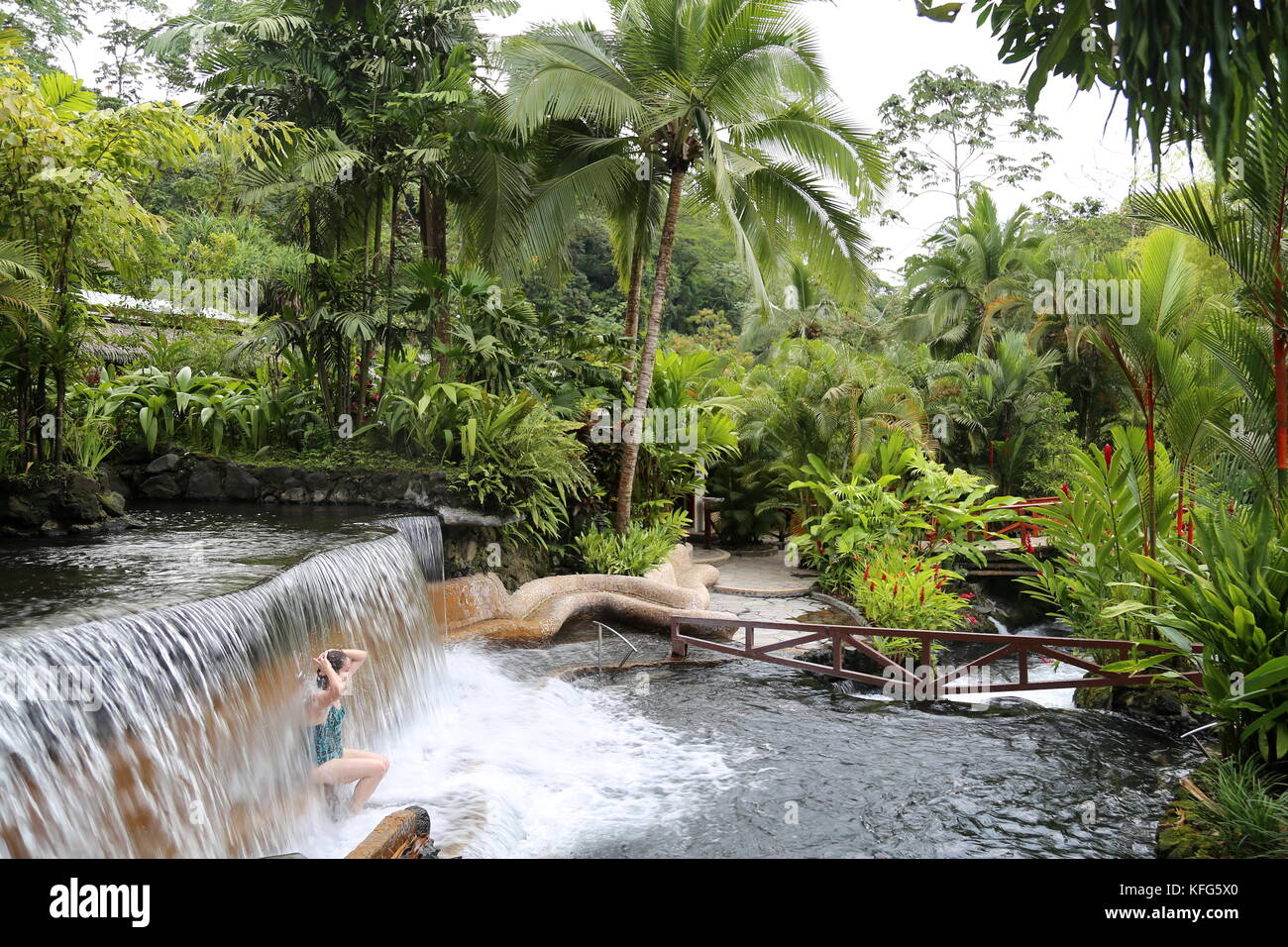 Young woman enjoys the thermal pools at Tabacón Hot Springs Resort and ...