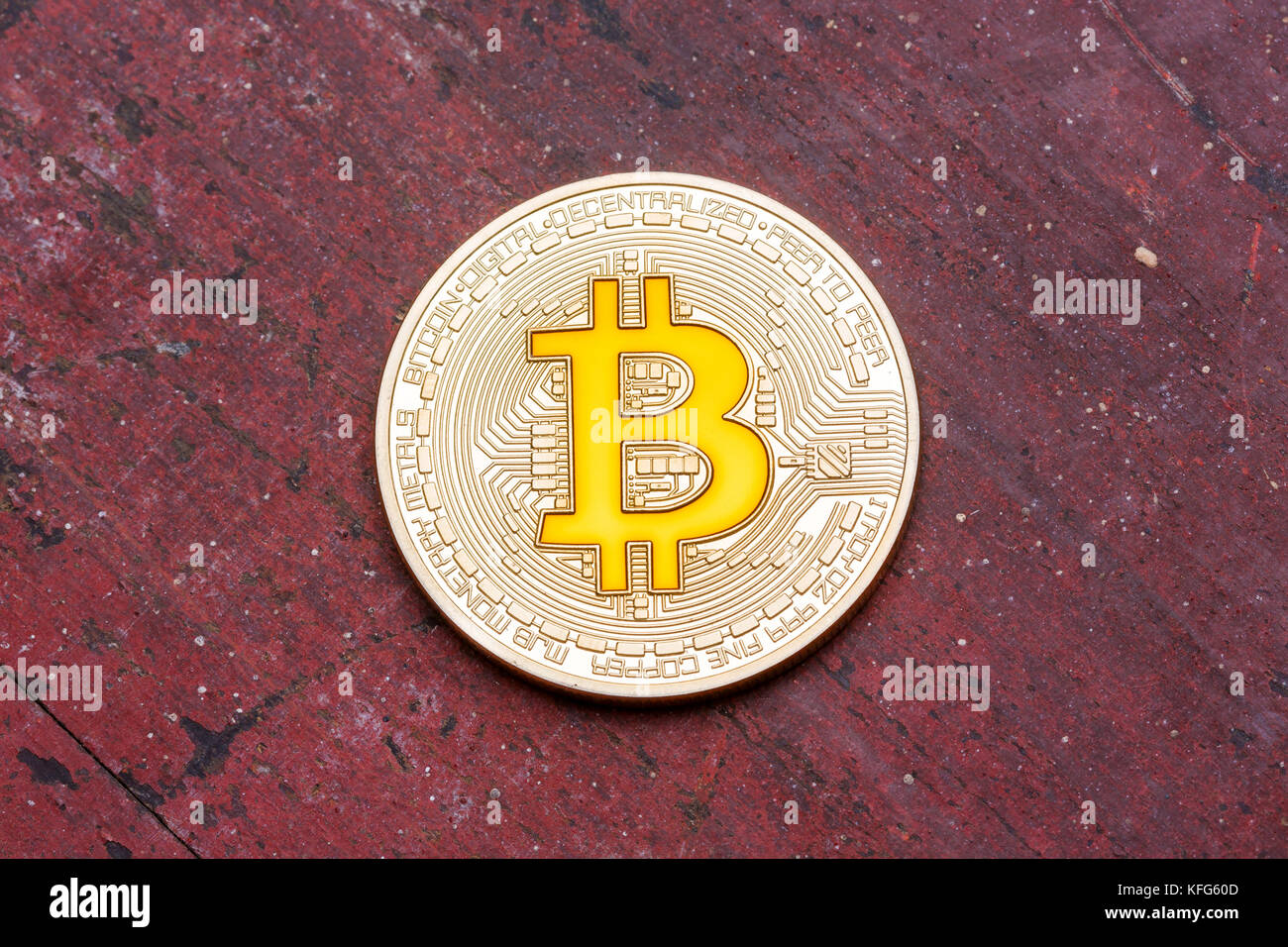 Golden cryptocurrency yellow bitcoin on red background Stock Photo - Alamy