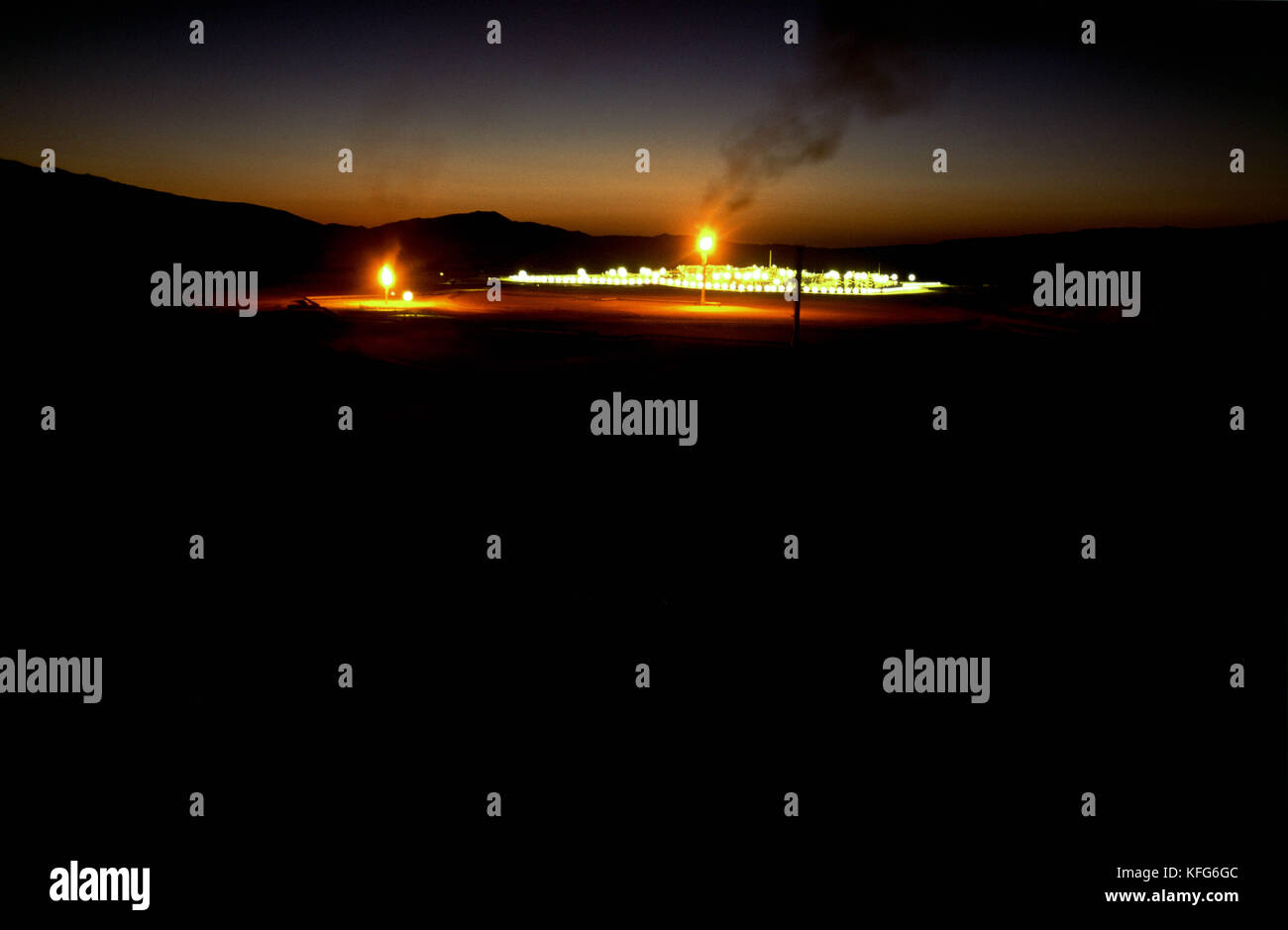 Sun sets behind a gas flare of the Shaybah Gas Oil Separation Plant ...