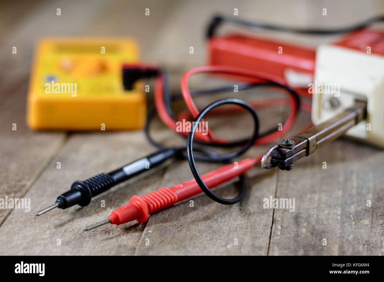 Electronic workshop. Electric meter and soldering iron Stock Photo - Alamy