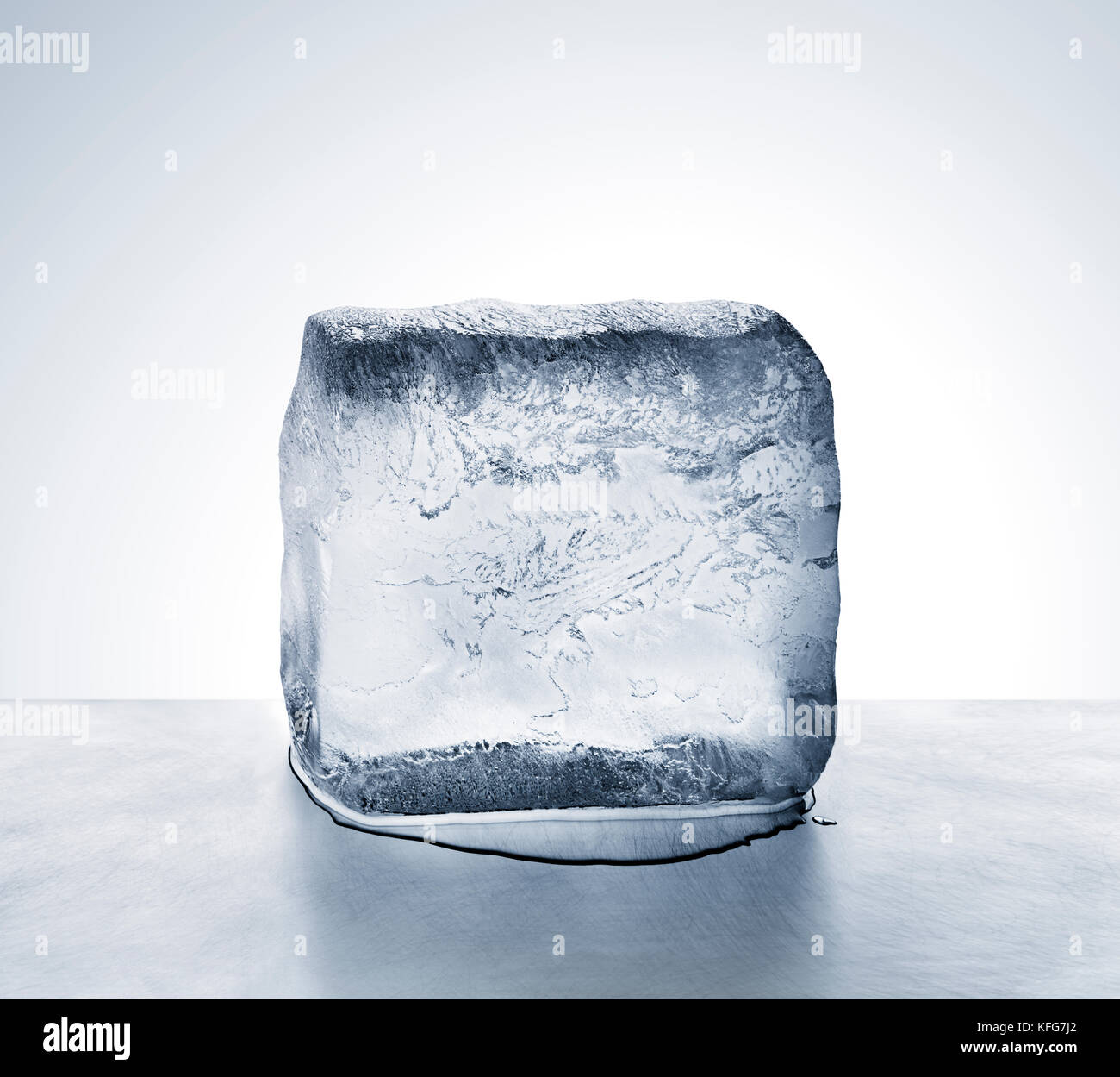 Frosty translucent, frigid cold blue ice block melting to create pool ...