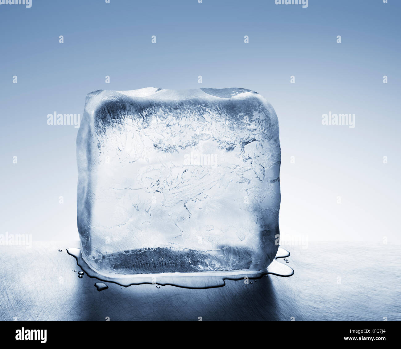 Frosty translucent, frigid cold blue ice block melting to create pool ...