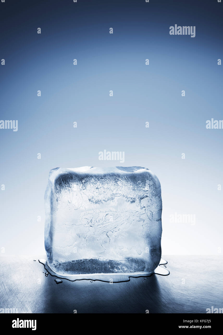 Frosty translucent, frigid cold blue ice block melting to create pool ...