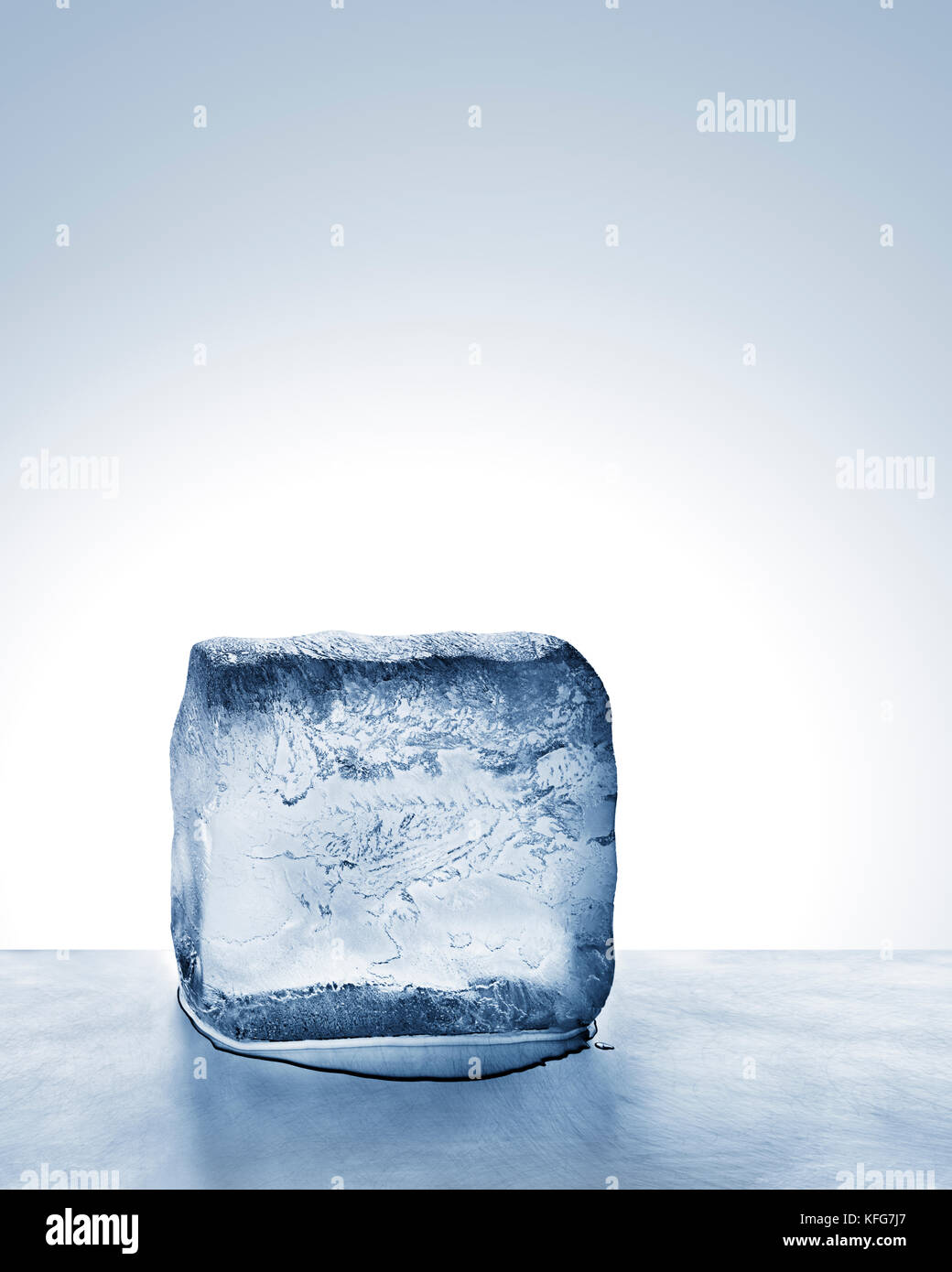 Frosty translucent, frigid cold blue ice block melting to create pool ...