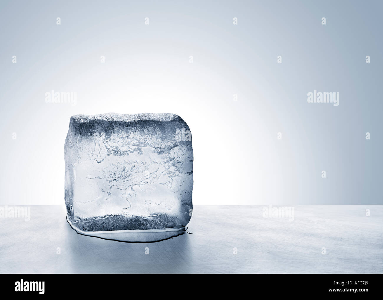 Frosty translucent, frigid cold blue ice block melting to create pool ...