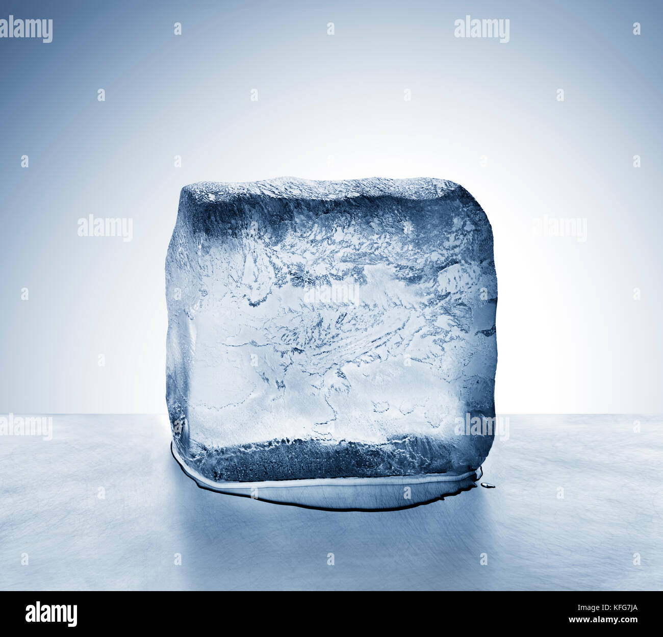 Frosty translucent, frigid cold blue ice block melting to create pool ...