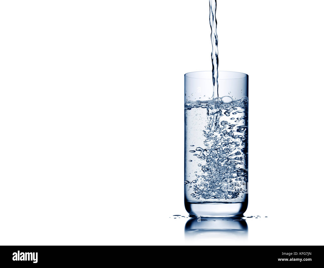 Water pouring and splashing into glass isolated on white with ...