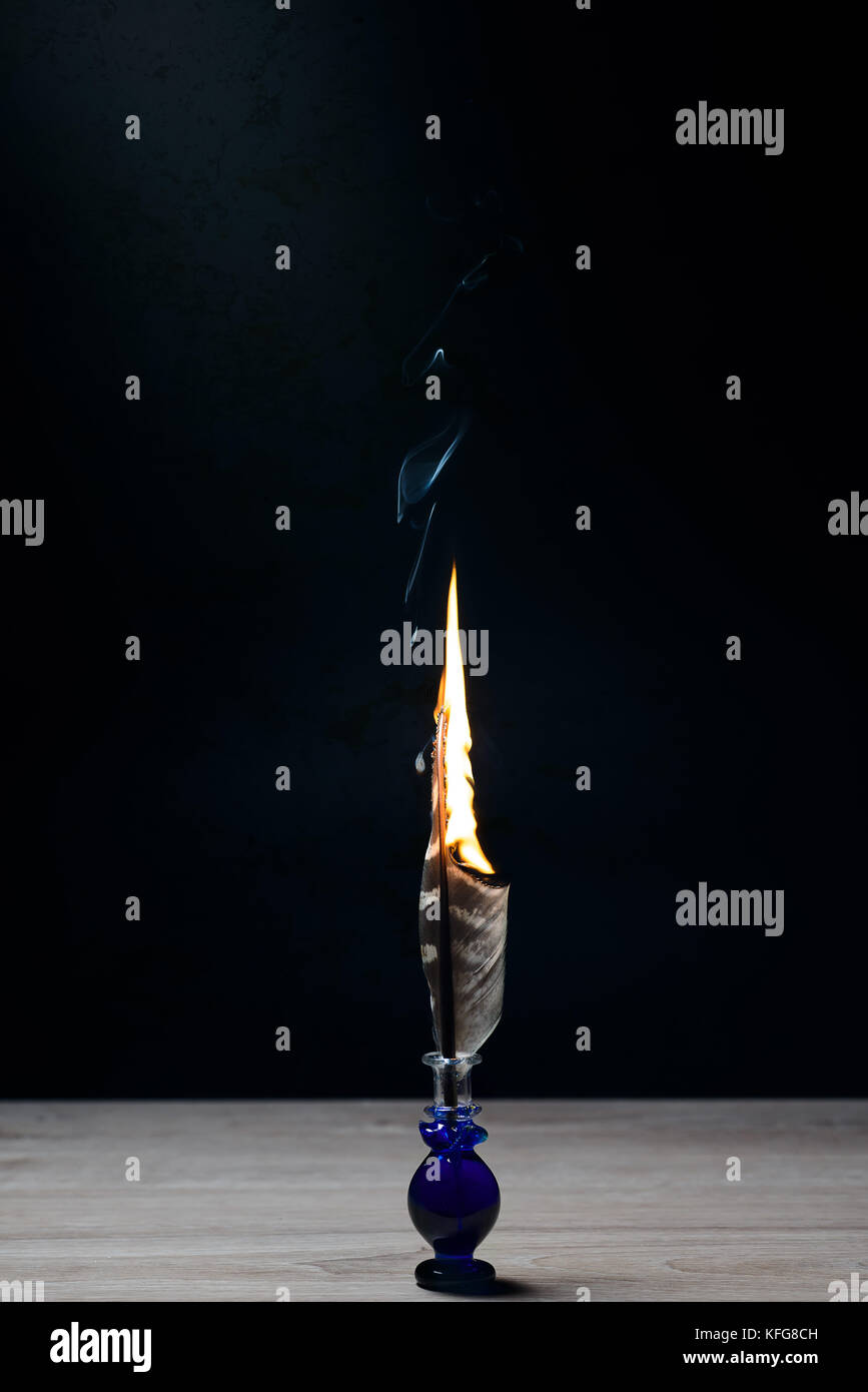 Burning writing feather in small ink bottle waiting for writer Stock ...