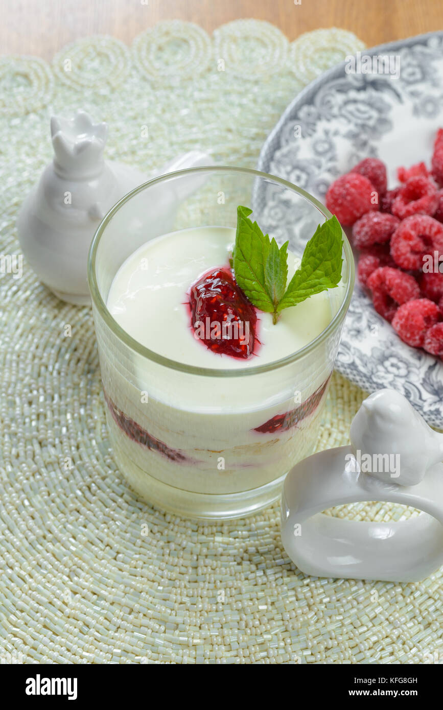 Raspberry cream dessert in clear glass on table Stock Photo - Alamy