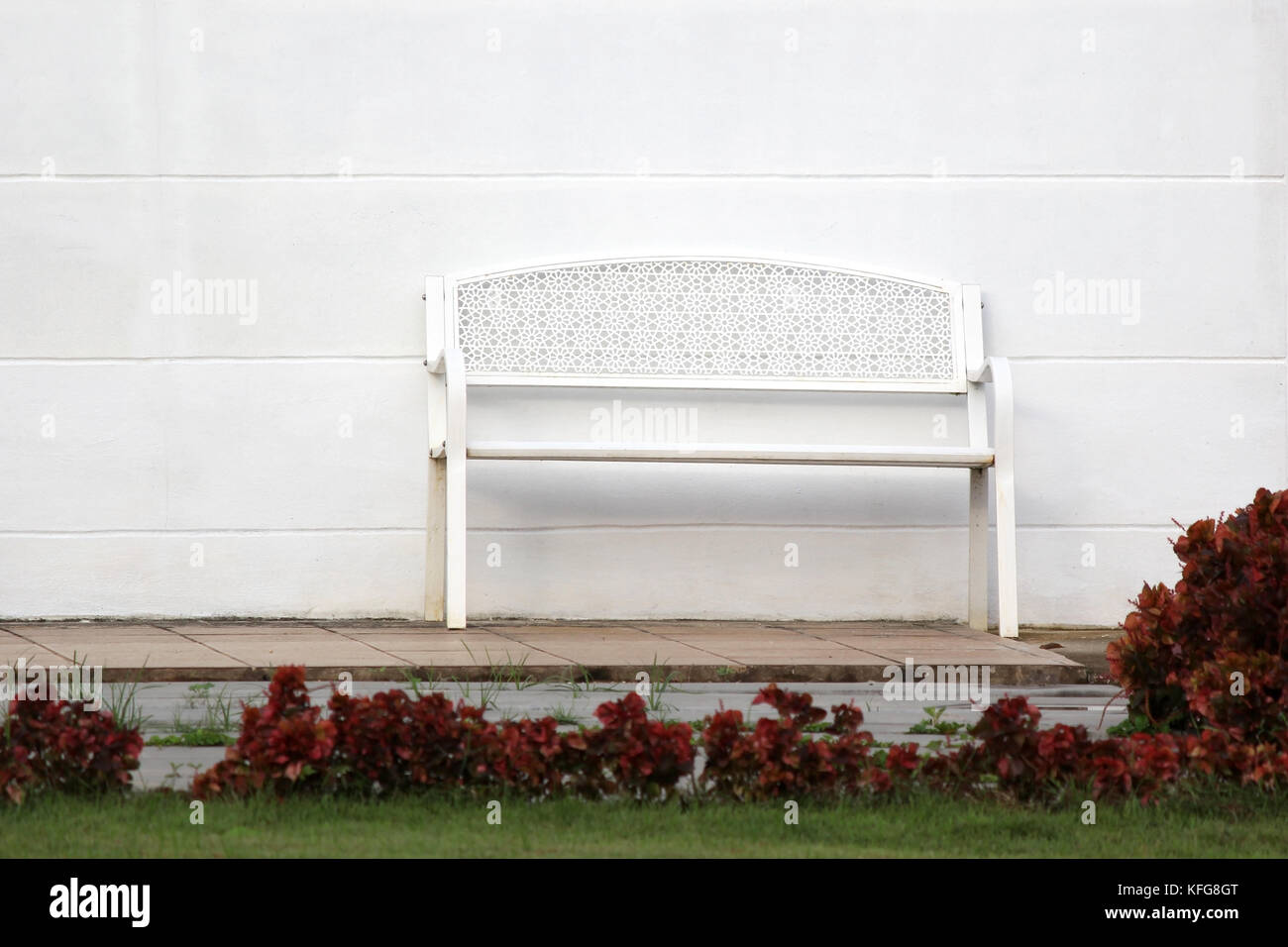 white steel bench on cement wall background Stock Photo - Alamy