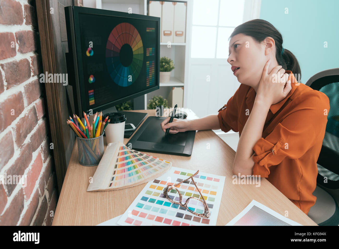 elegant young female designer using digital pad pen drawing design ...