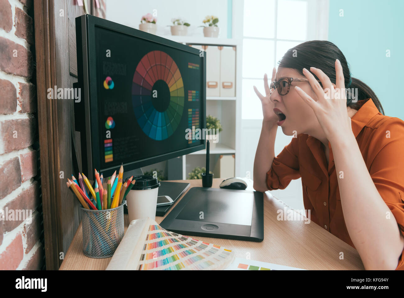 professional pretty woman designer looking at screen getting crazy when ...