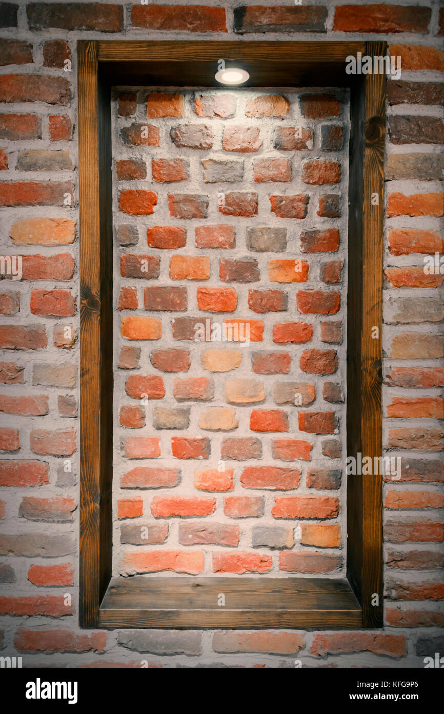 Frame with spotlight with brick wall background Stock Photo - Alamy