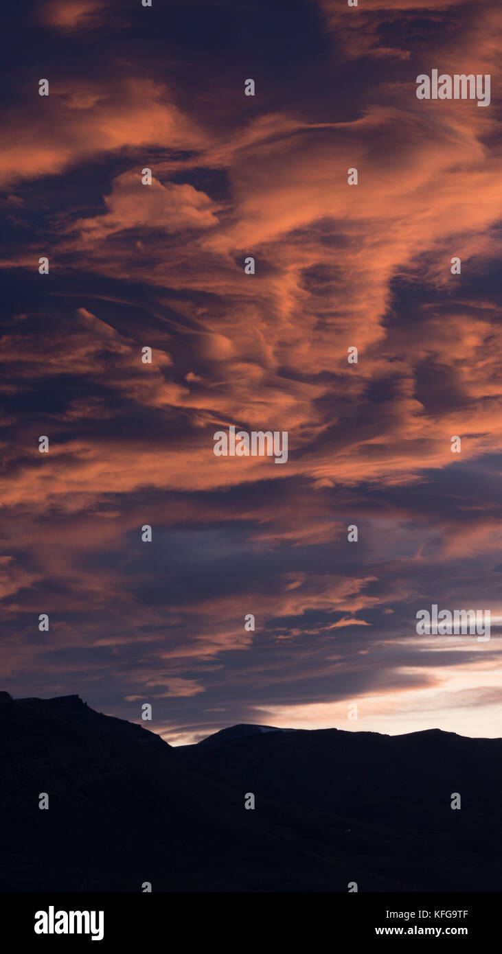 Dramatic sunset of layered red and pink and red clouds over Andes ...