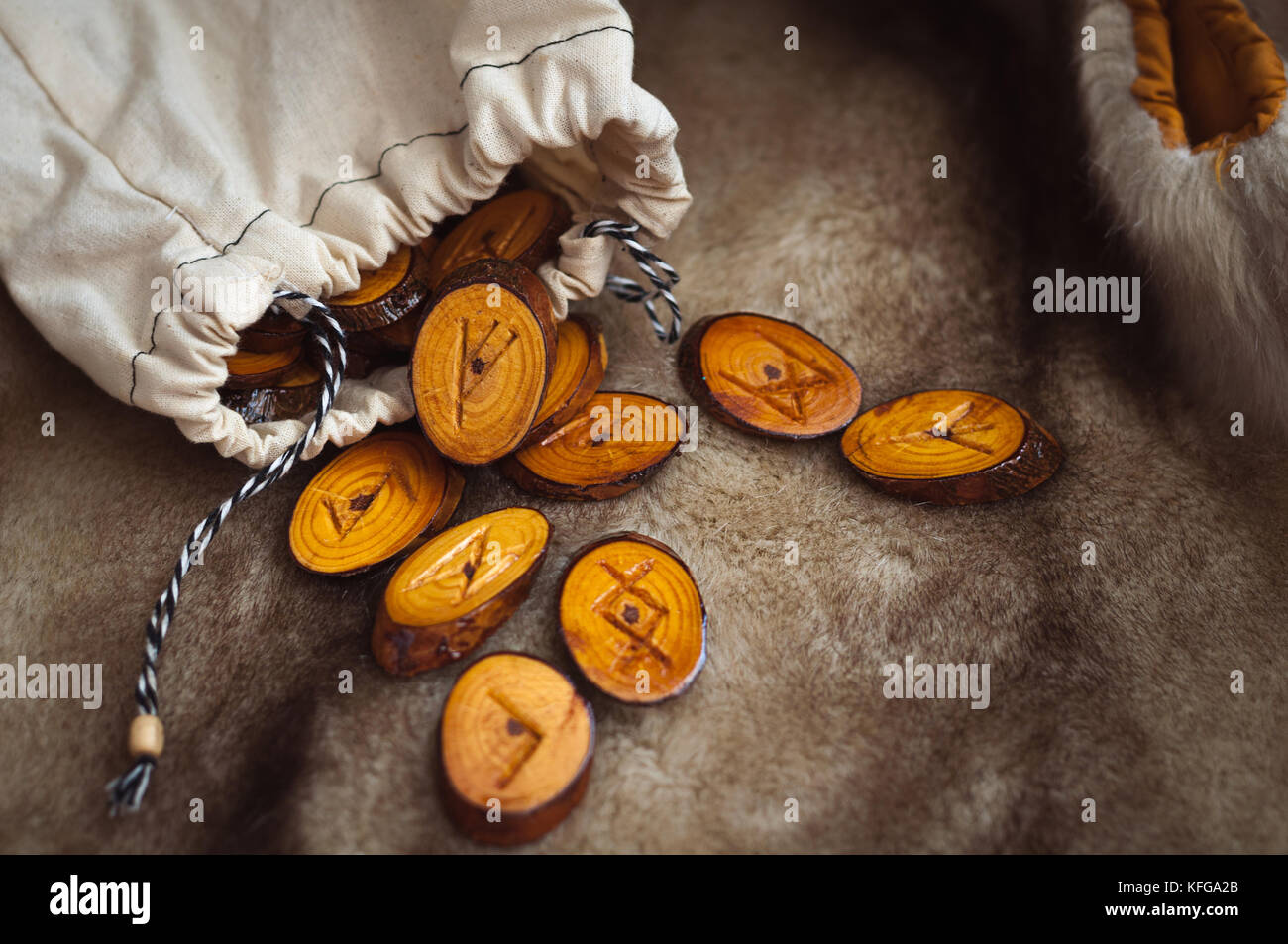 wood runes handmade fur are lying beside the crystal ball and semi ...