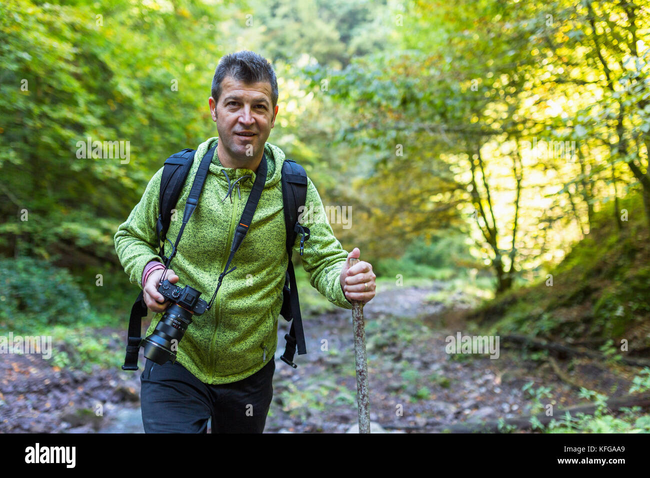Tourist with camera hiking on a trail by the river Stock Photo - Alamy