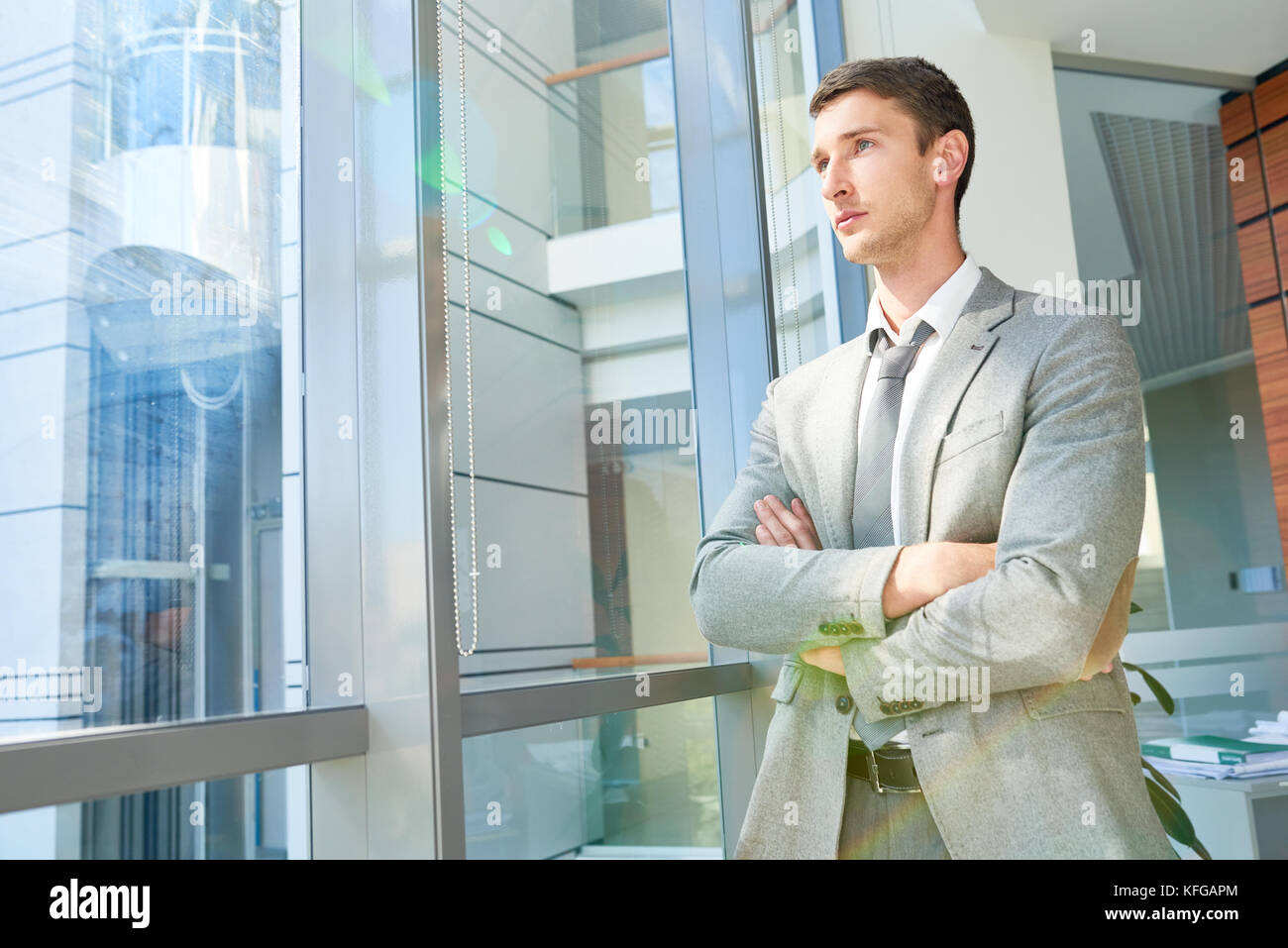 Successful Businessman by Window Stock Photo - Alamy