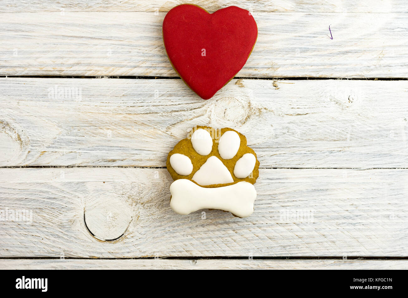 Gingerbread in the shape of a dog's paw and red heart. White background ...
