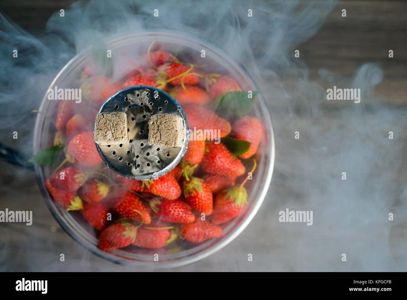 Smoking hookah with fruit head on blue background Stock Photo - Alamy