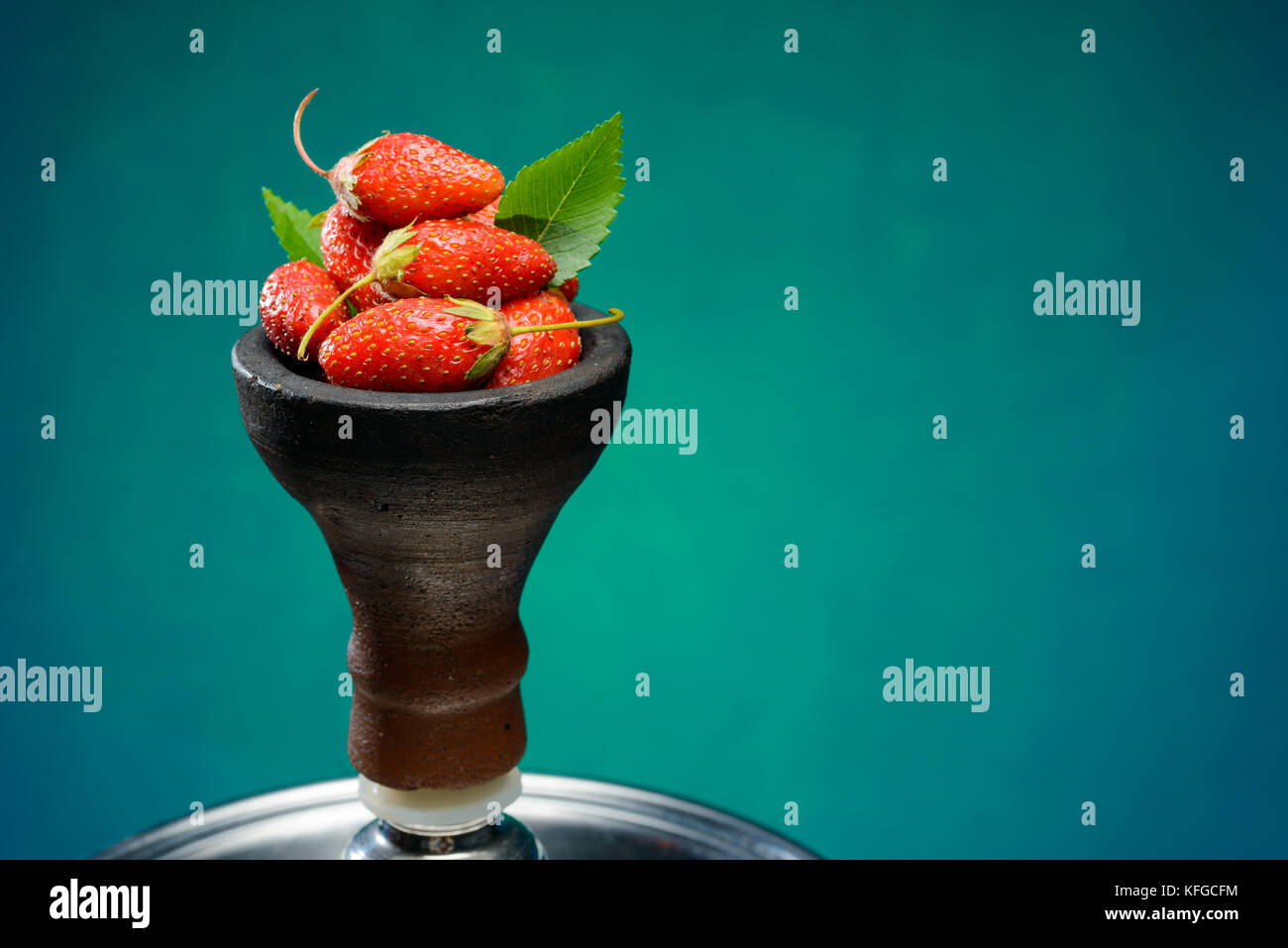 Smoking hookah with fruit head on blue background Stock Photo - Alamy
